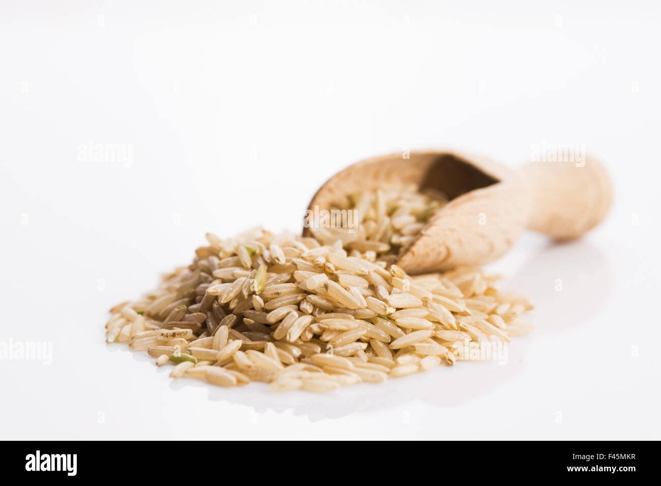 Whole rice pile on white background Stock Photo - Alamy