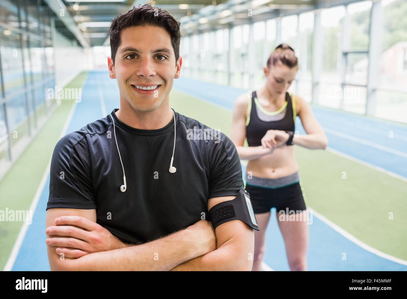 Fit couple on the indoor track Stock Photo - Alamy