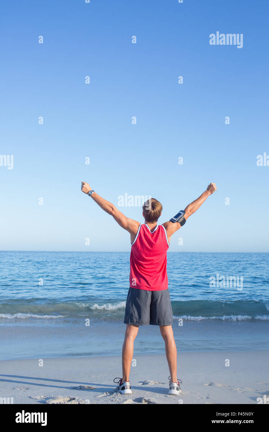 Handsome man raising arms Stock Photo - Alamy