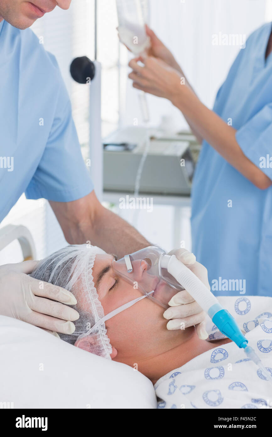Doctor holding patients oxygen mask Stock Photo - Alamy