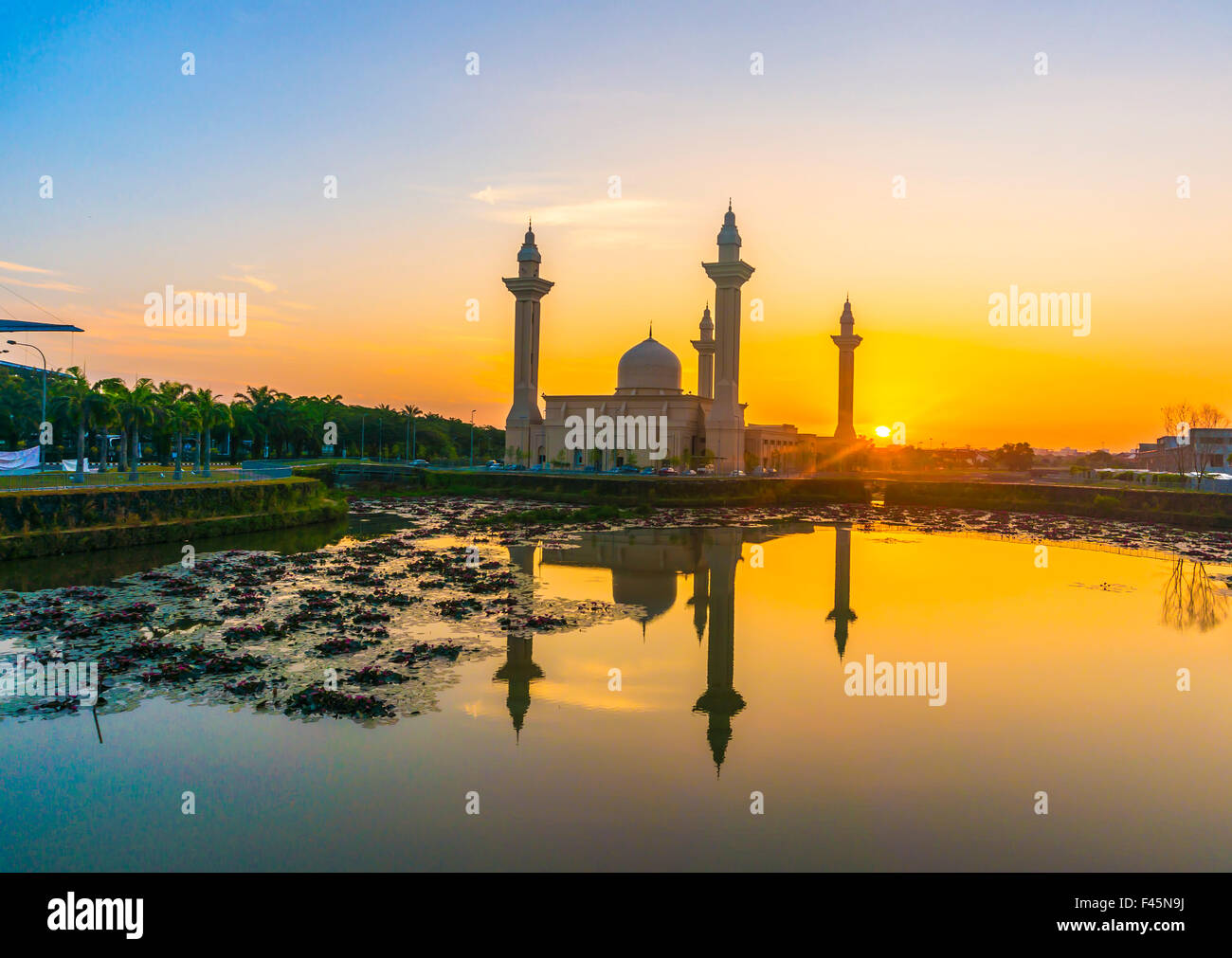Mosque and sunrise reflection on lake Stock Photo - Alamy