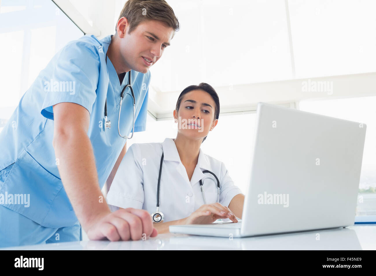 Doctors working on laptop computer Stock Photo - Alamy