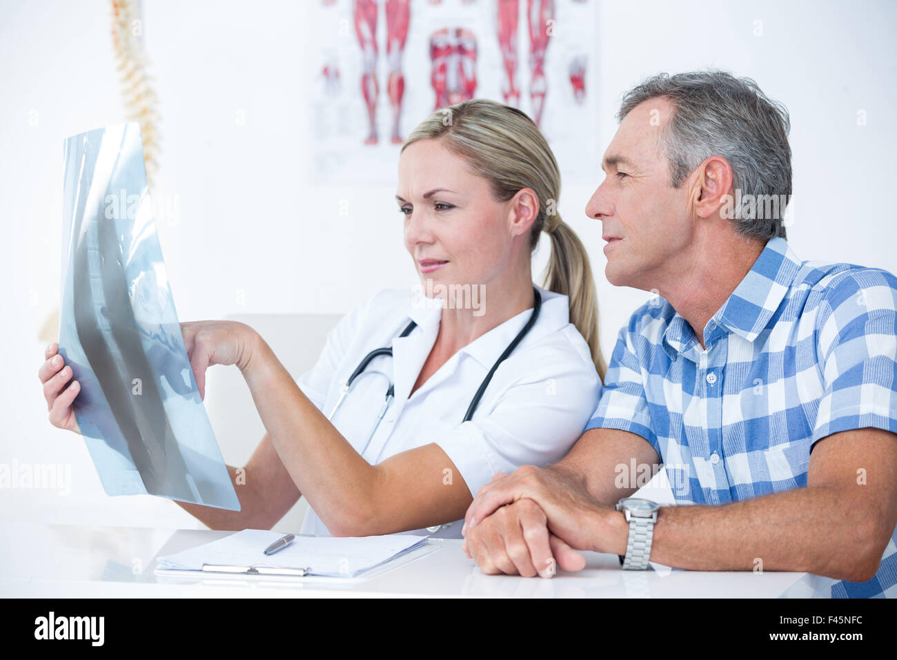 Doctor showing X rays to her patient Stock Photo - Alamy