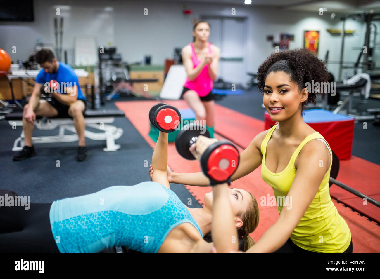 Fit people working out in weights room Stock Photo - Alamy