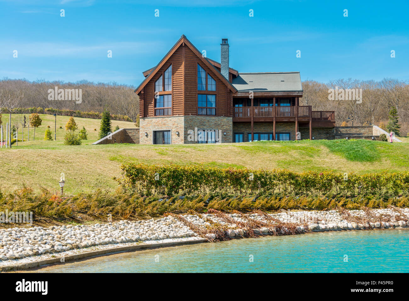 Modern house near water on bright day Stock Photo - Alamy