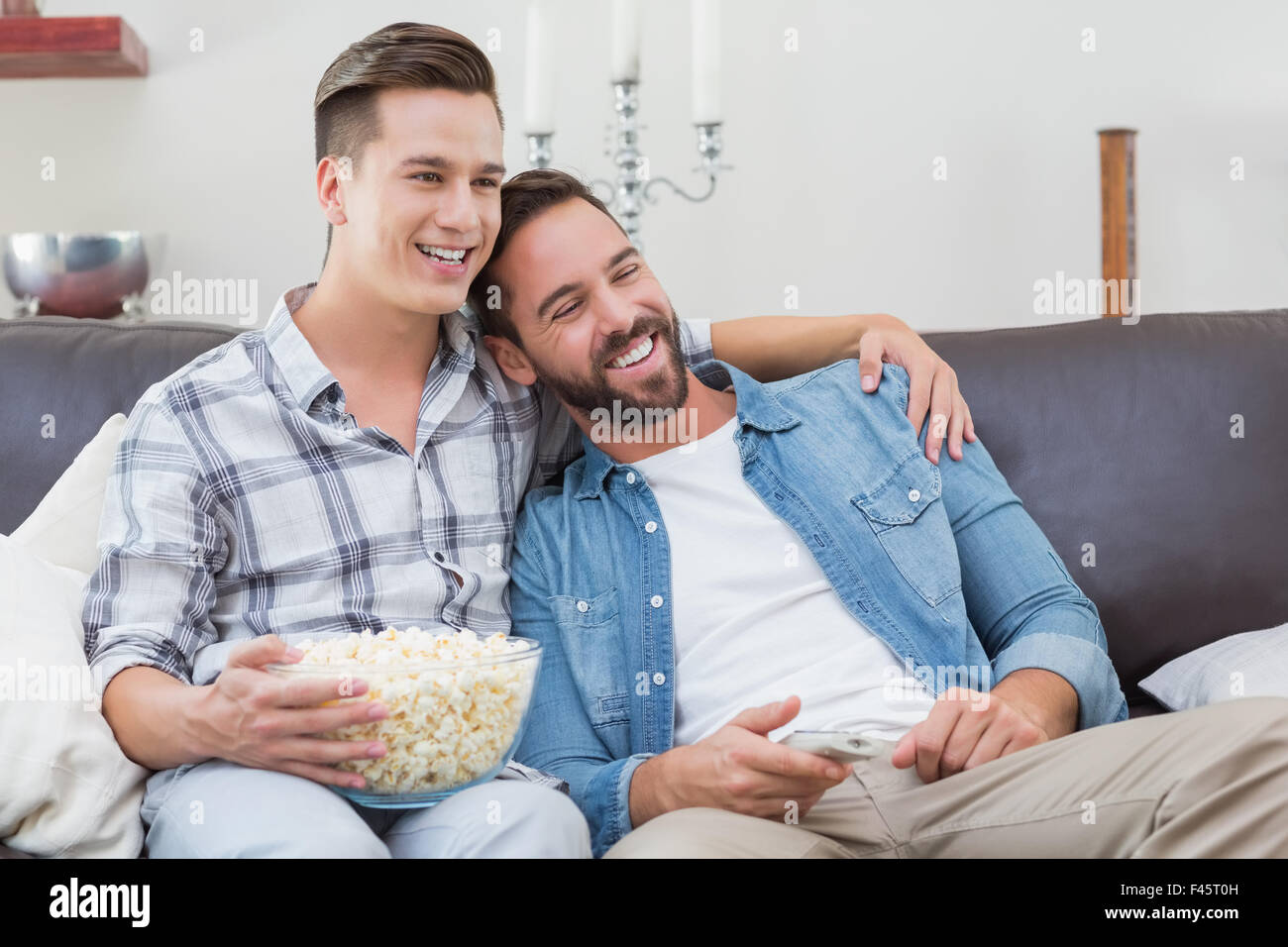 Homosexual couple men eating popcorn together Stock Photo - Alamy