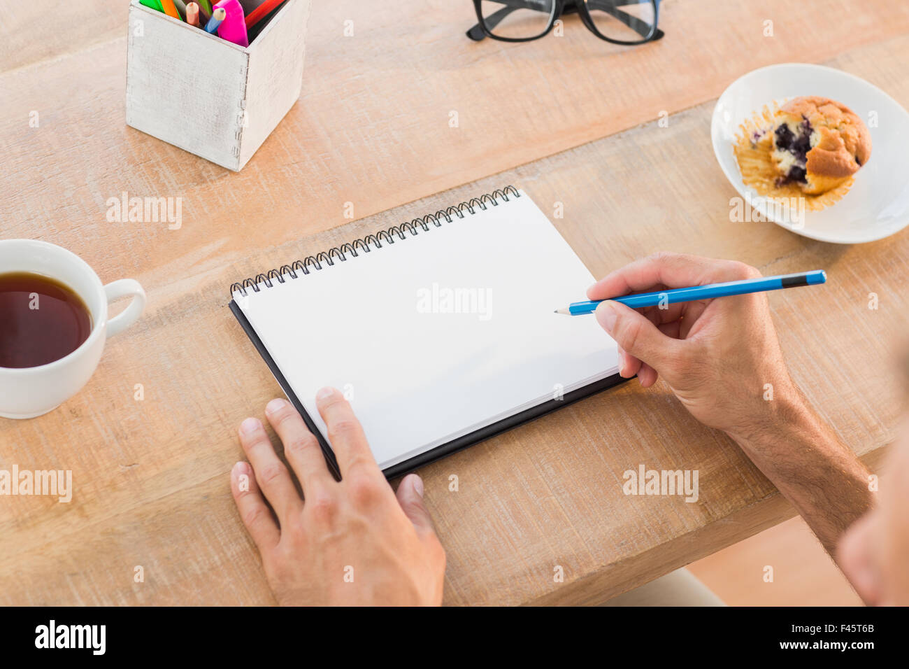 Man writing notes on notebook Stock Photo - Alamy
