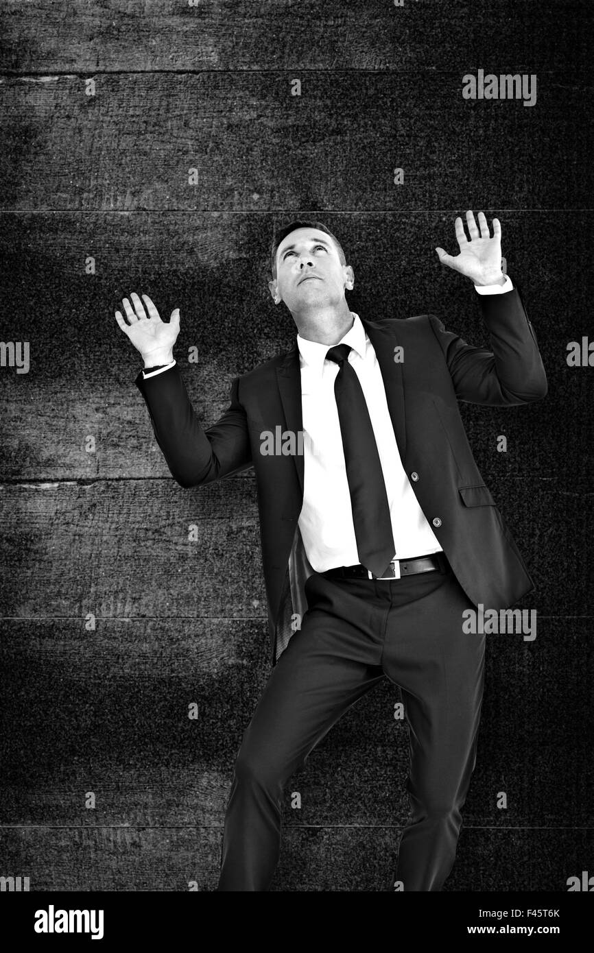Composite image of businessman with hands up Stock Photo - Alamy