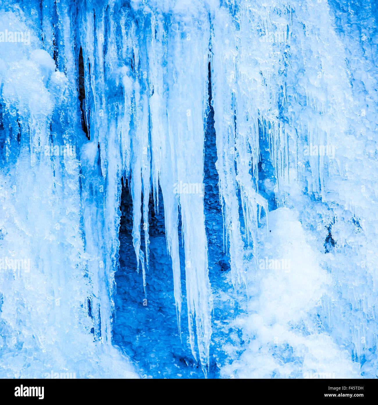Frozen waterfall of blue icicles Stock Photo - Alamy