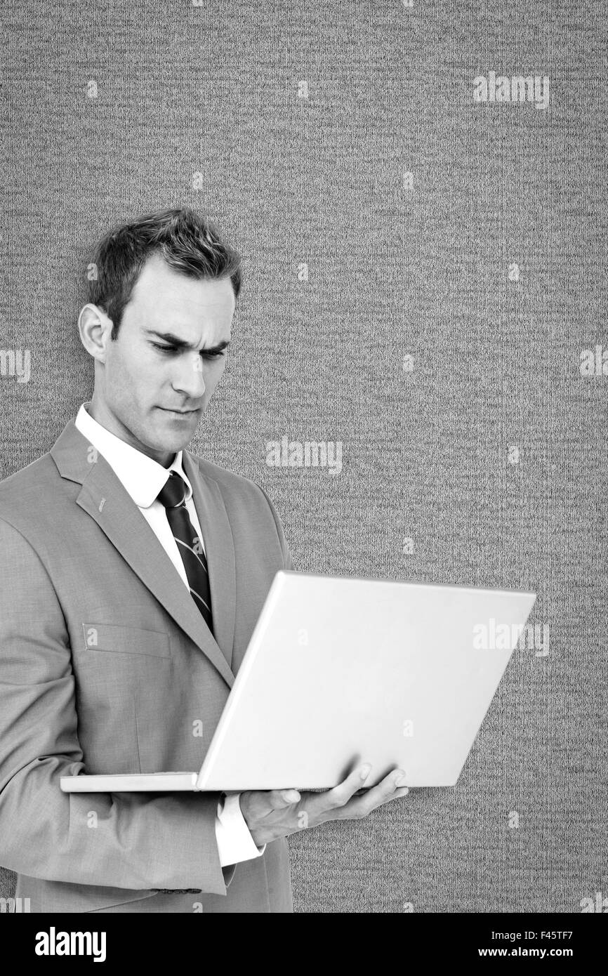 Composite image of businessman using laptop Stock Photo - Alamy