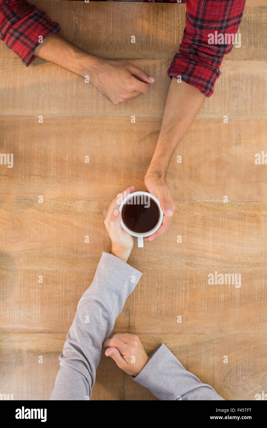 Two hands holding cup hi-res stock photography and images - Alamy