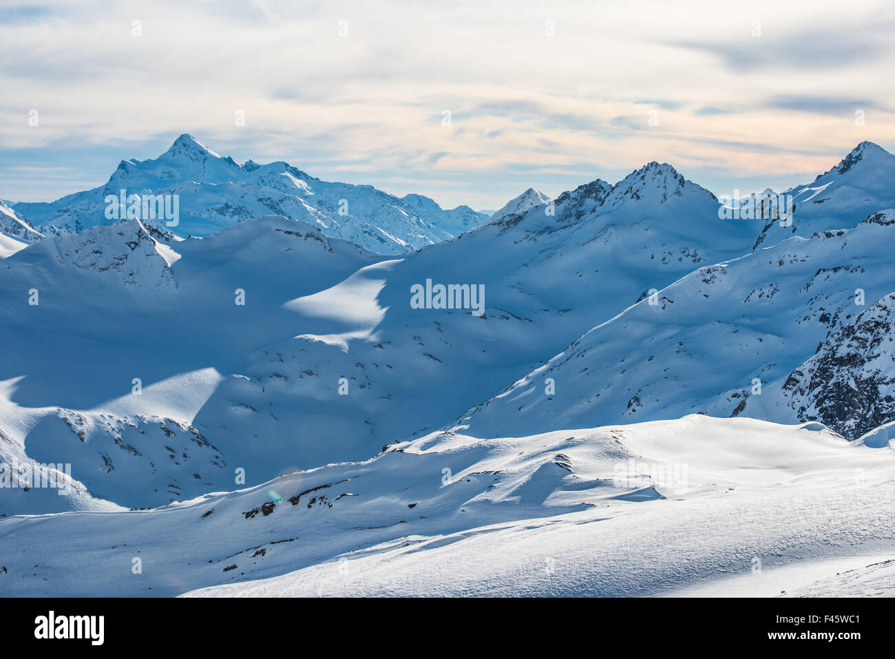 Snowy blue mountains in clouds Stock Photo - Alamy
