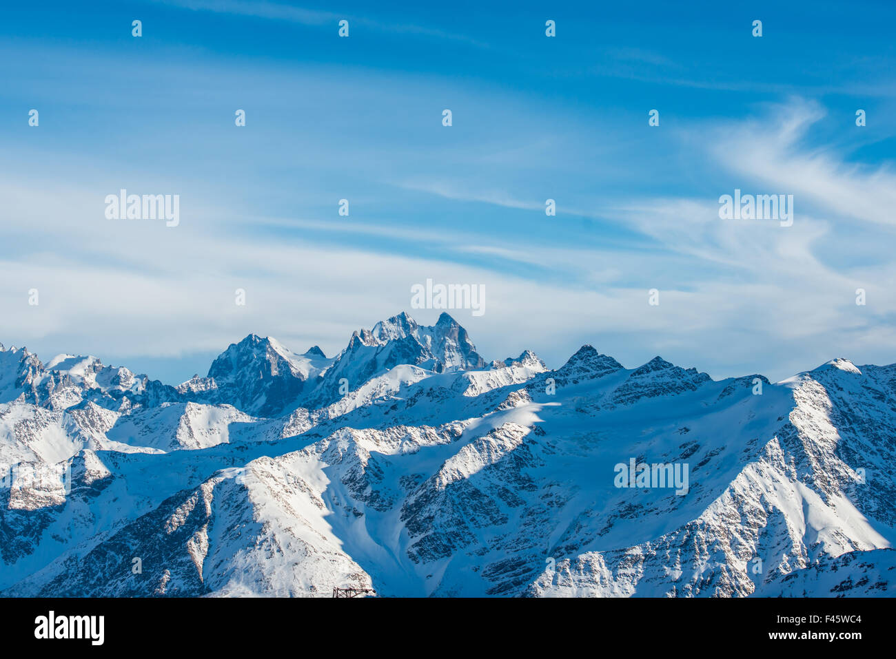 Snowy blue mountains in clouds Stock Photo - Alamy