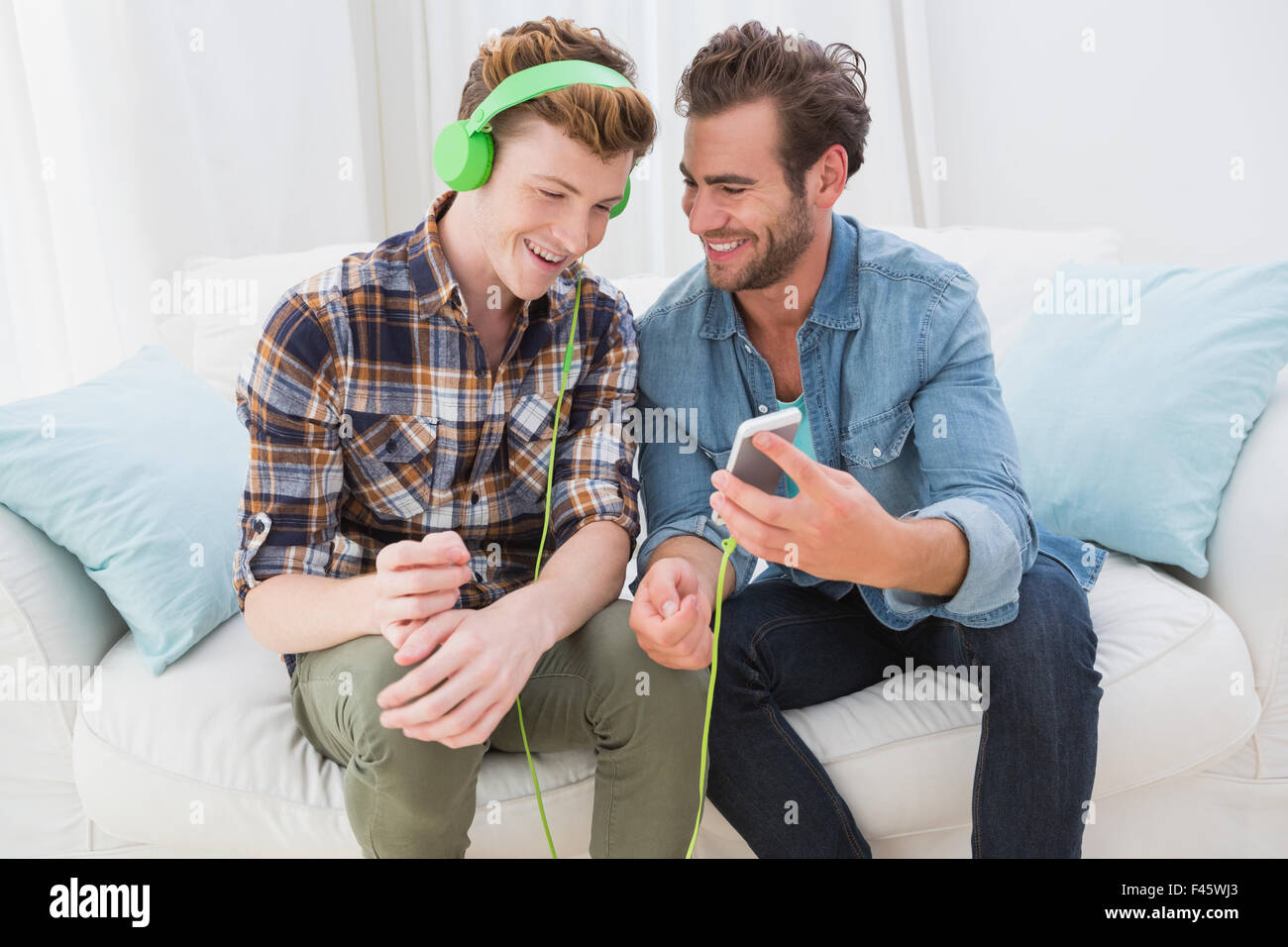 Homosexual couple men listening to music Stock Photo - Alamy