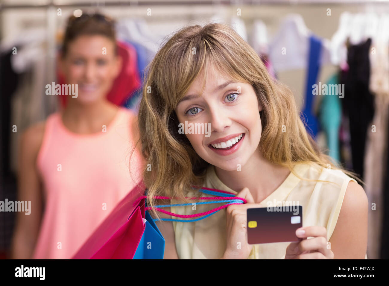 Beautiful customer holding shopping bags and credit card Stock Photo ...