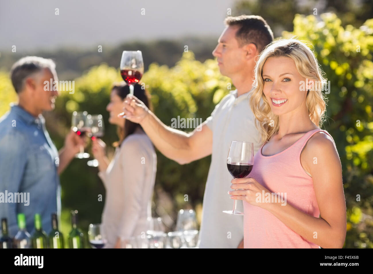 Couple doing wine tasting in front of other couple talking and drinking ...