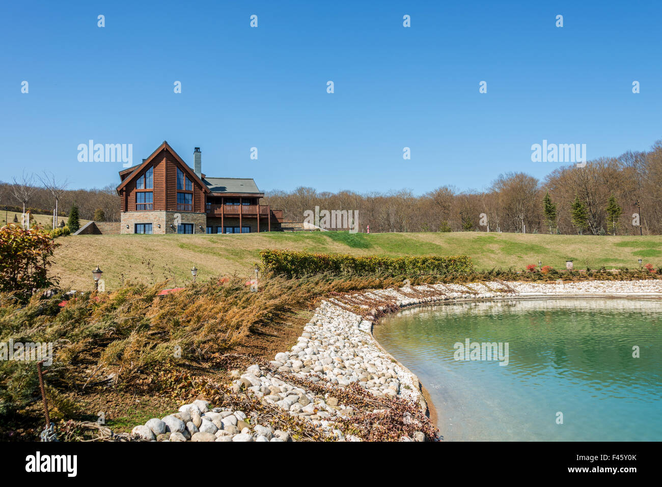 Modern house near water on bright day Stock Photo - Alamy