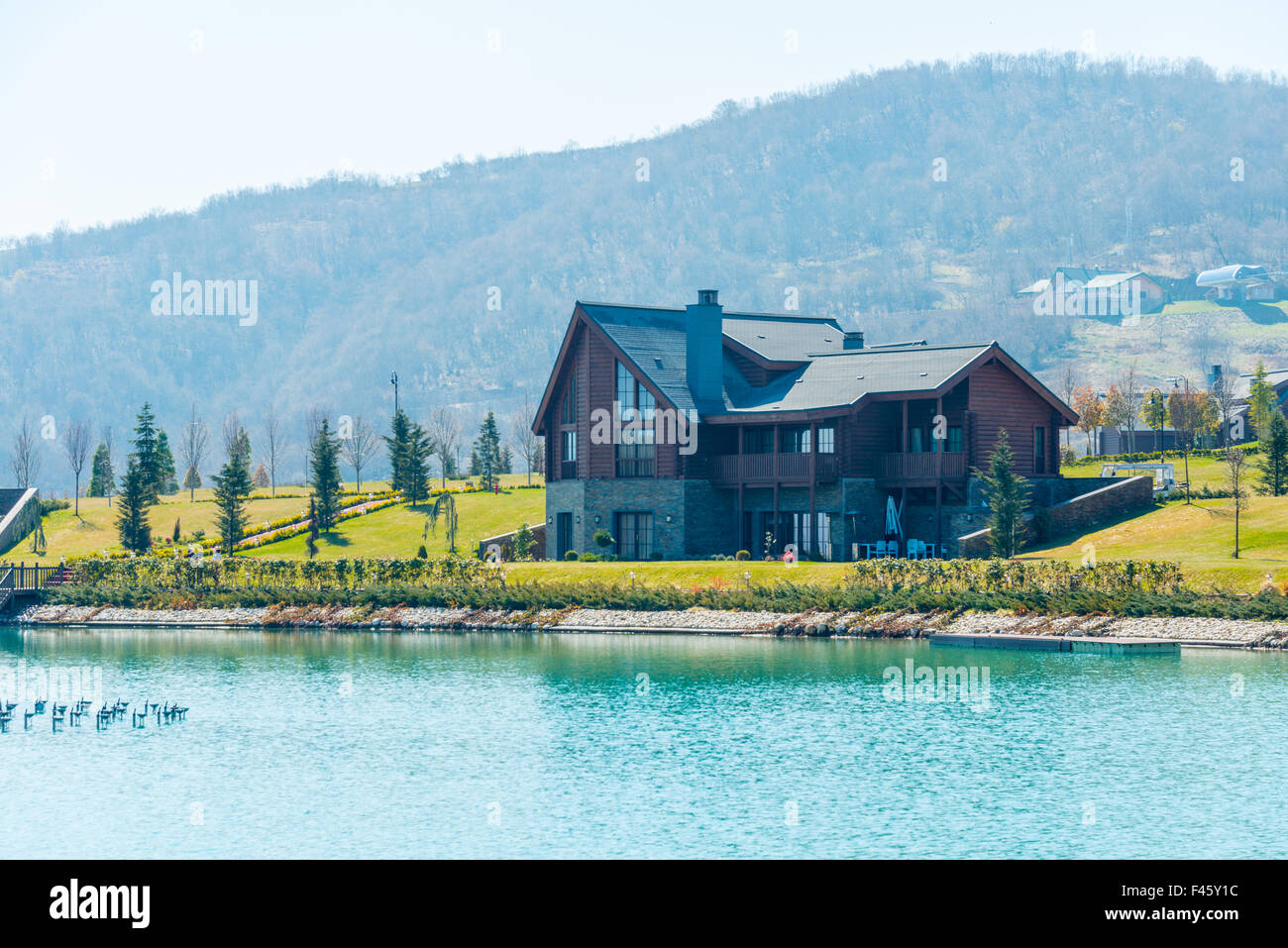 Modern house near water on bright day Stock Photo - Alamy