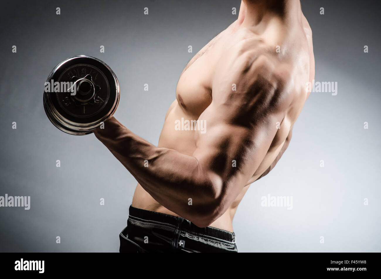 Muscular ripped bodybuilder with dumbbells Stock Photo - Alamy