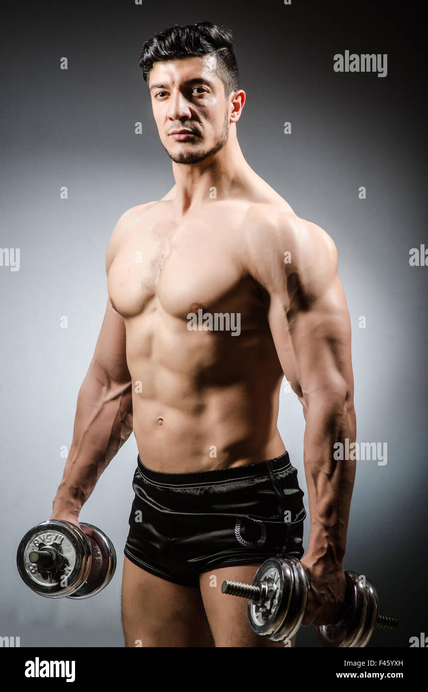 Muscular ripped bodybuilder with dumbbells Stock Photo - Alamy