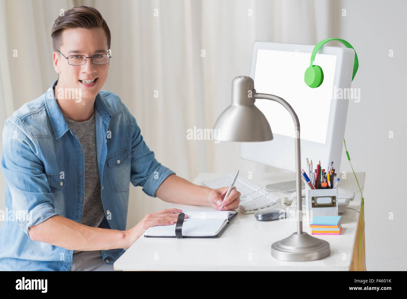 Handsome cheerful young man writing hi-res stock photography and images ...