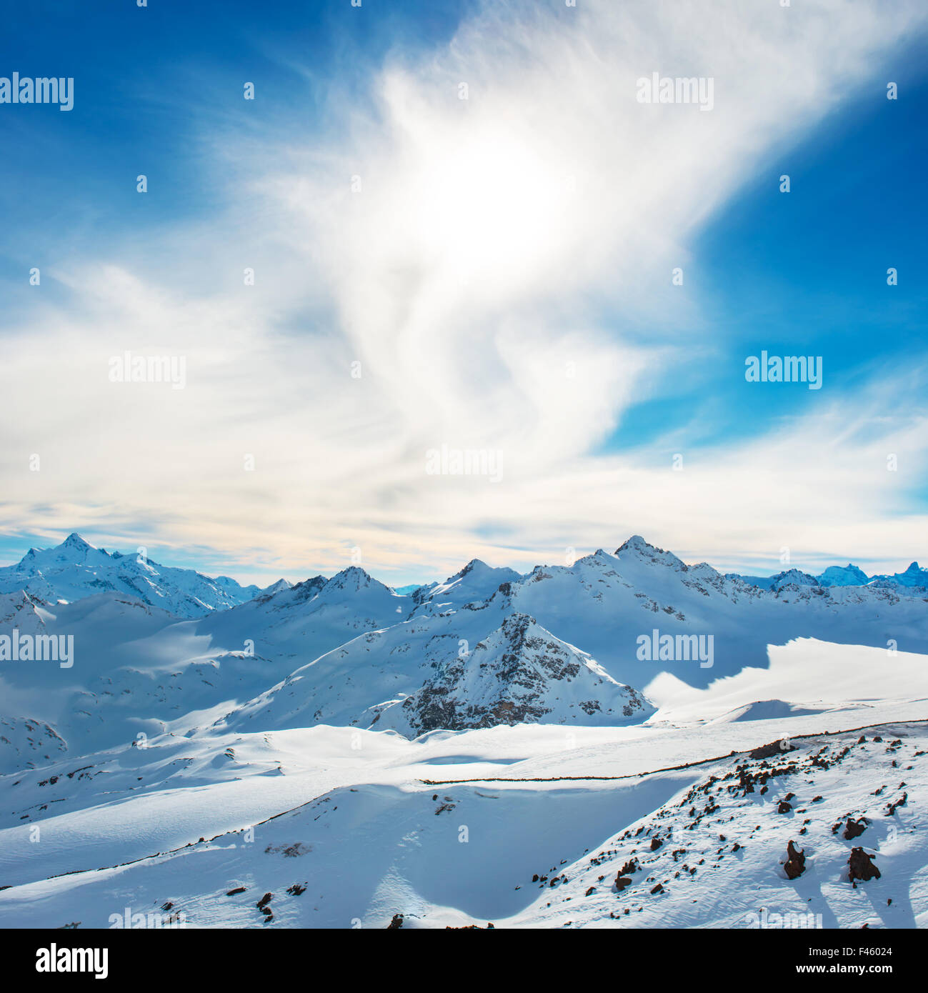 Snowy blue mountains in clouds Stock Photo - Alamy