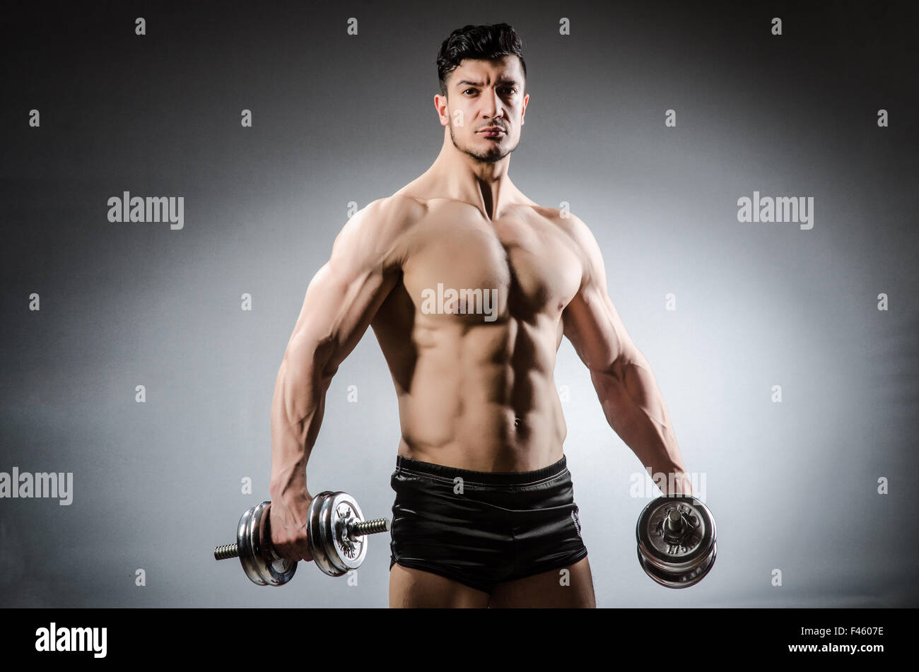 Muscular ripped bodybuilder with dumbbells Stock Photo - Alamy