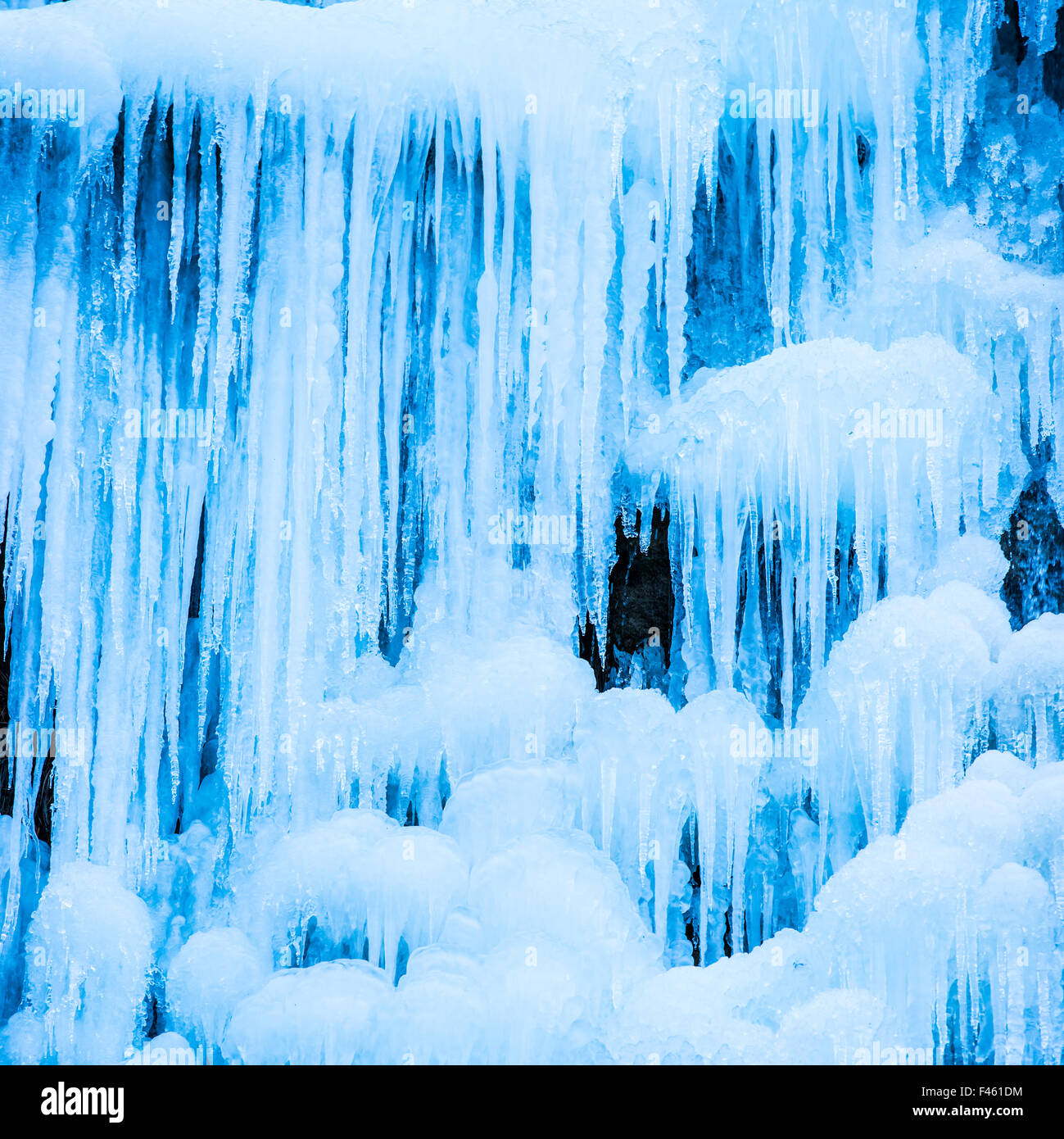 Frozen waterfall of blue icicles Stock Photo - Alamy