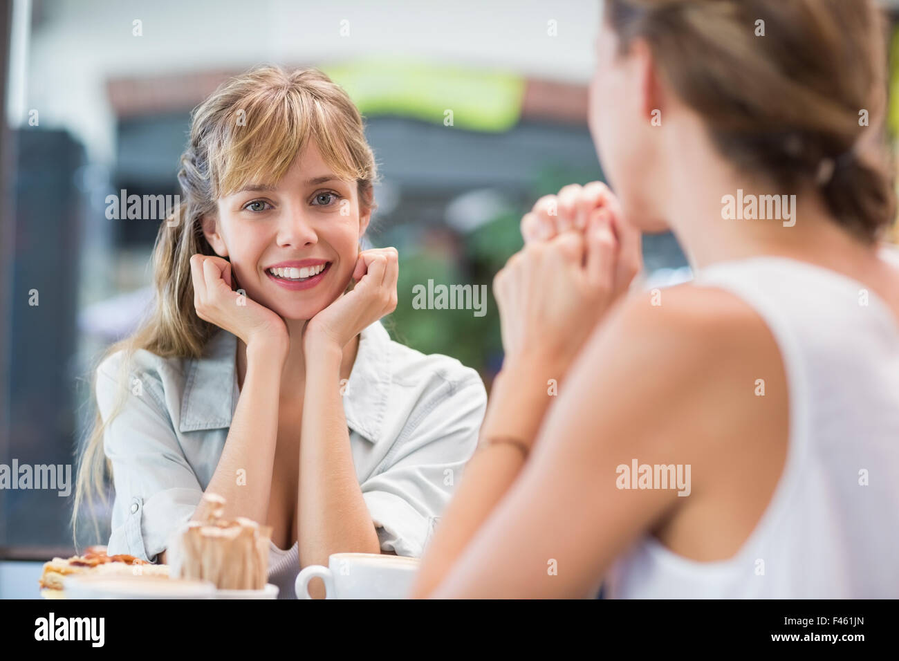 Beautiful women talking and looking at camera Stock Photo - Alamy