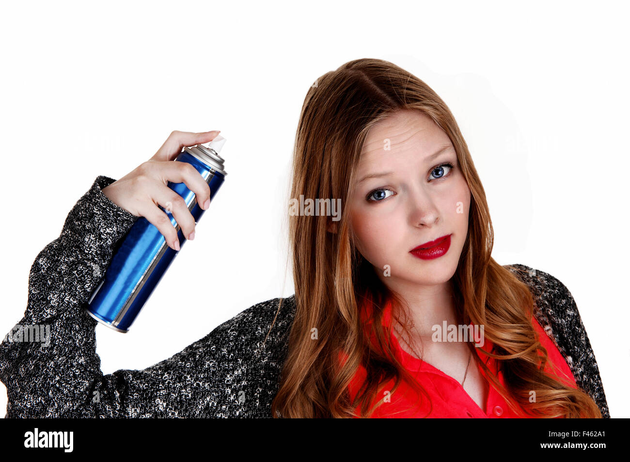 Girl putting hairspray on Stock Photo - Alamy