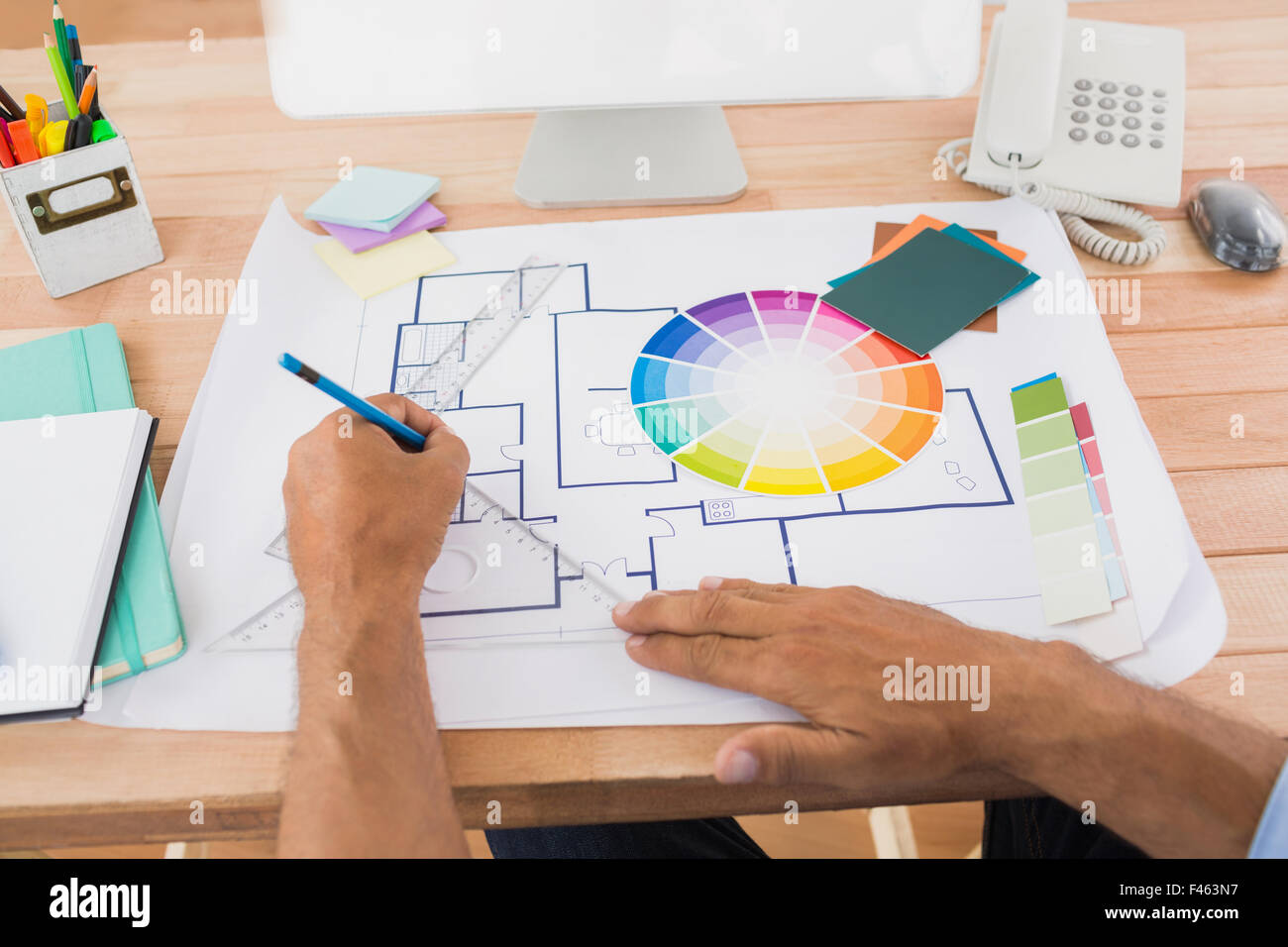 Hands drawing plans beside color watch Stock Photo - Alamy