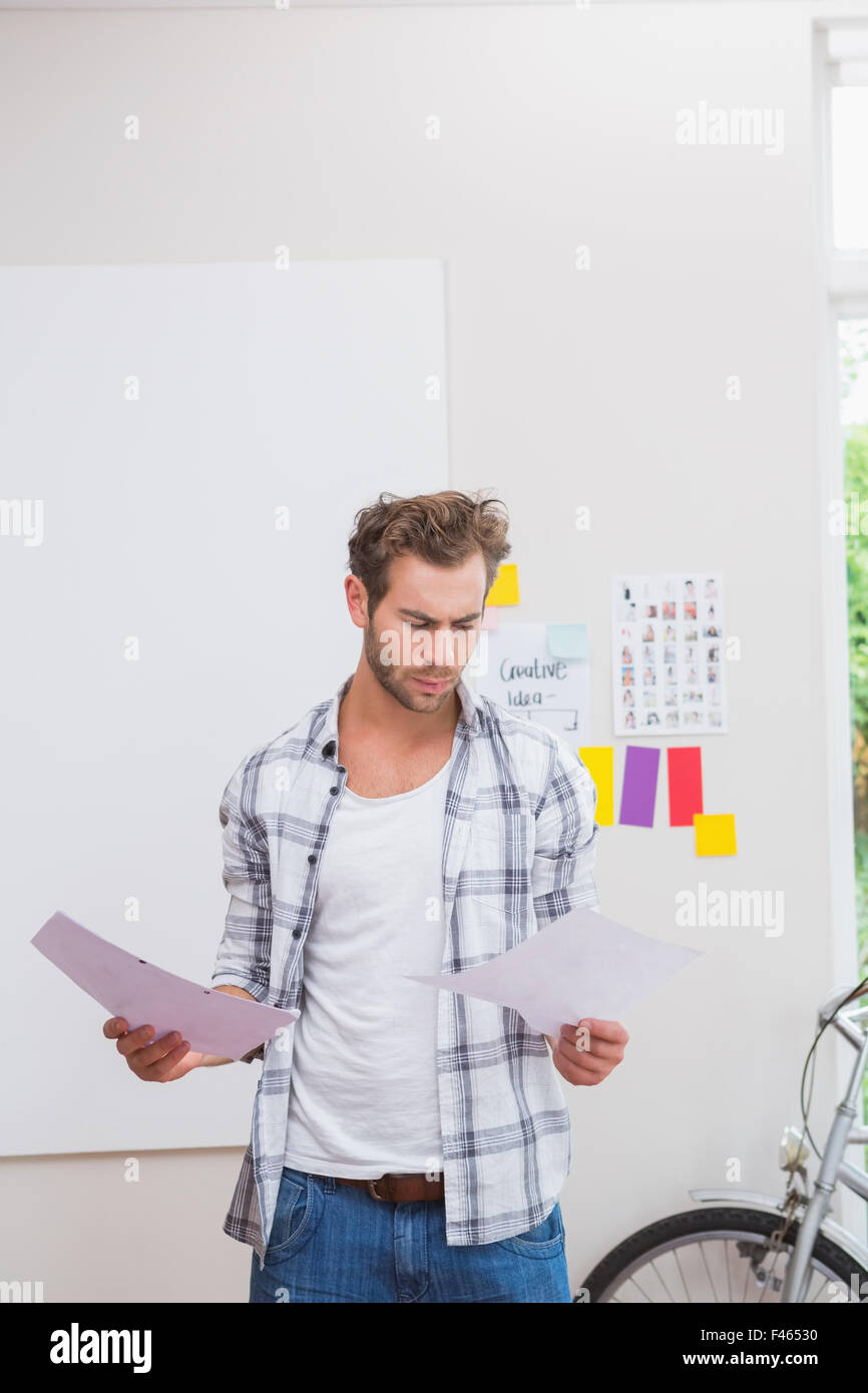 Serious handsome man looking at piece of paper Stock Photo - Alamy