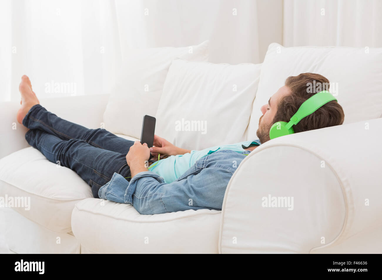 Handsome man listening music with his smartphone Stock Photo - Alamy