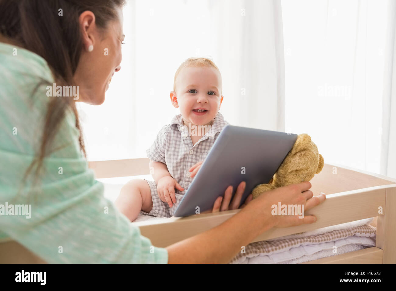 Baby playing digital tablet mother hi-res stock photography and images ...