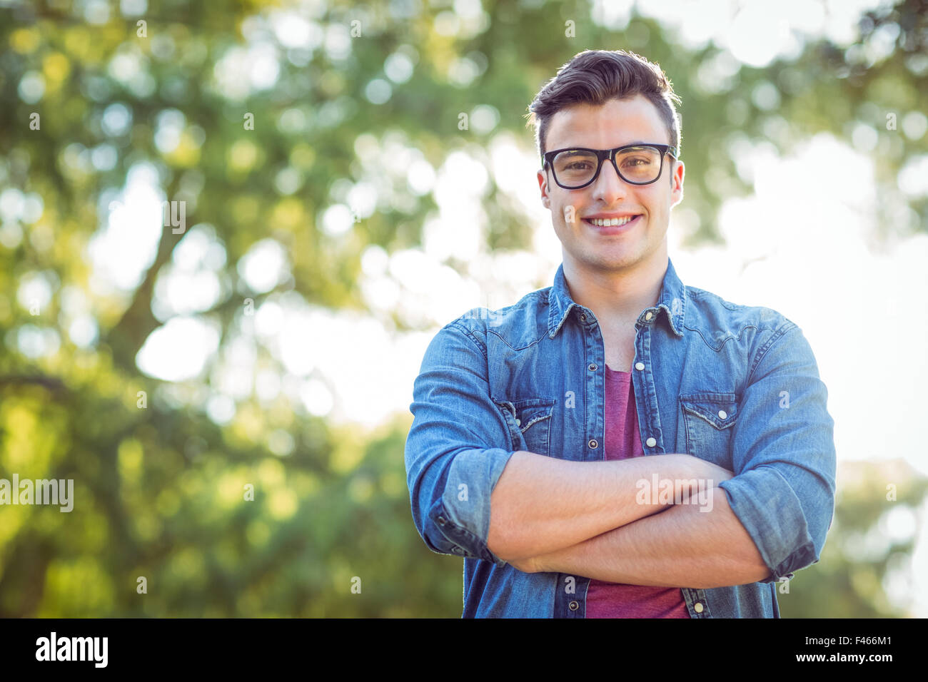 Happy hipster looking at camera Stock Photo - Alamy