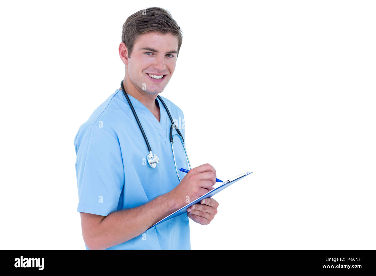 Young nurse in blue tunic writing notes Stock Photo - Alamy