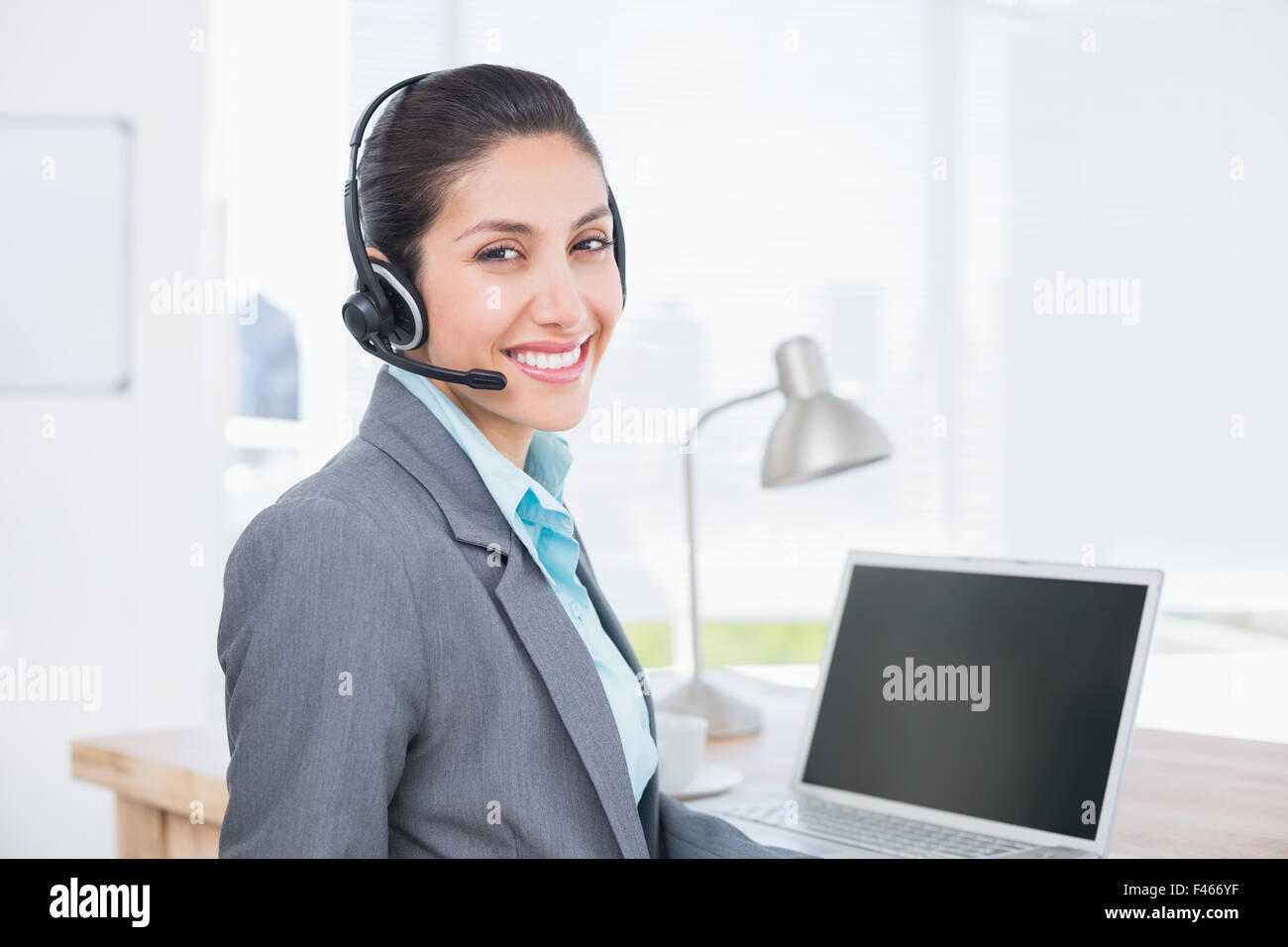Businesswoman wearing a work headset Stock Photo - Alamy