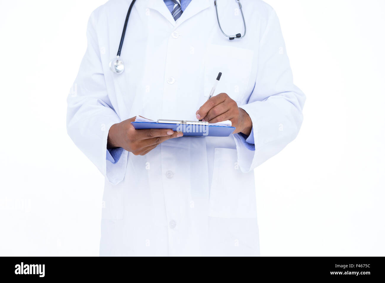 Standing doctor in white tunic writing notes Stock Photo - Alamy