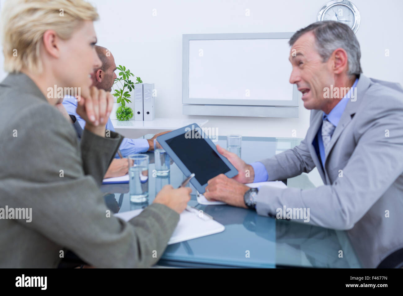 Colleagues speaking about work Stock Photo - Alamy