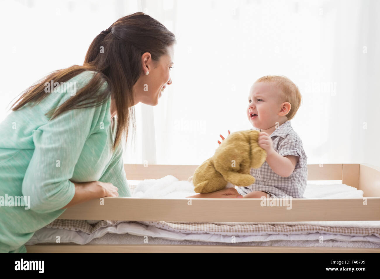 Mother interacting baby playing teddy hi-res stock photography and ...