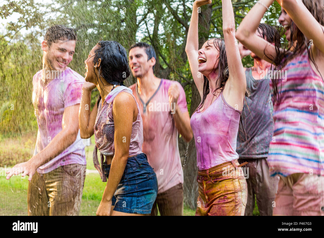 Happy friends covered in powder paint Stock Photo - Alamy