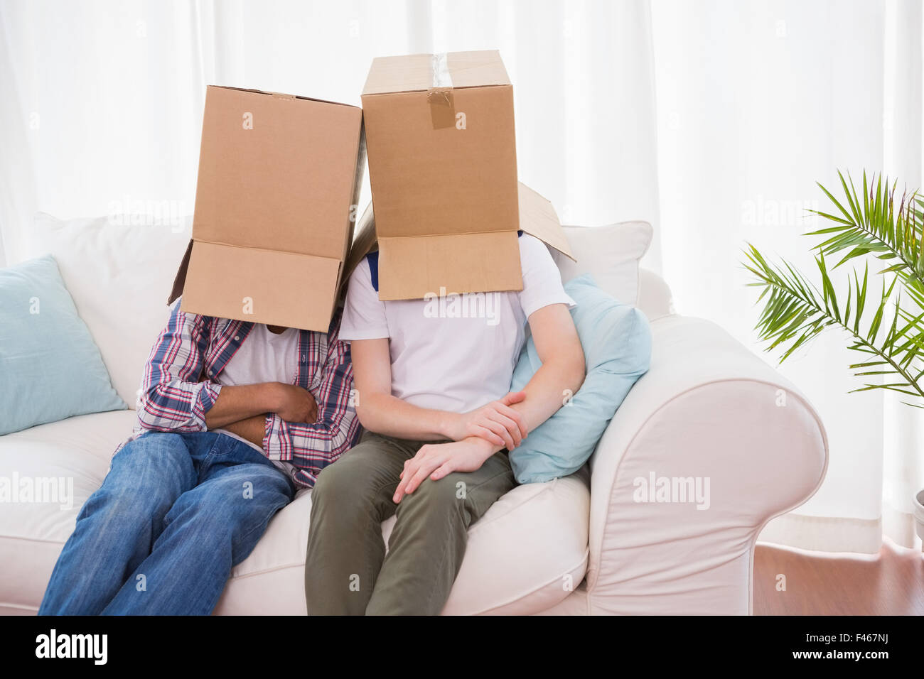 Homosexual couple wearing boxes over head Stock Photo - Alamy