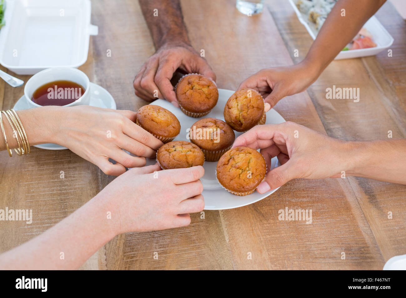 People taking a cupcake Stock Photo - Alamy