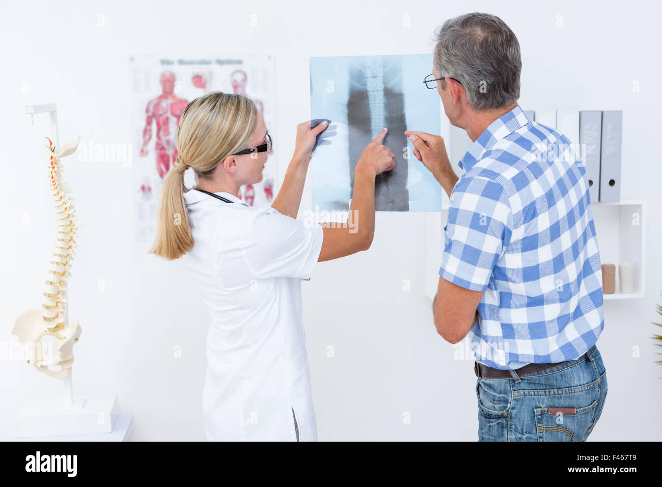 Doctor showing X rays to her patient Stock Photo - Alamy
