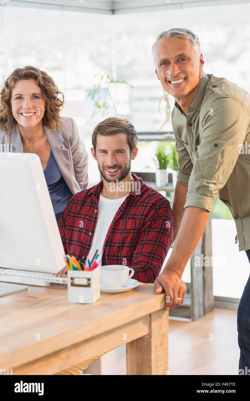Mature woman smiling coworkers typing hi-res stock photography and ...