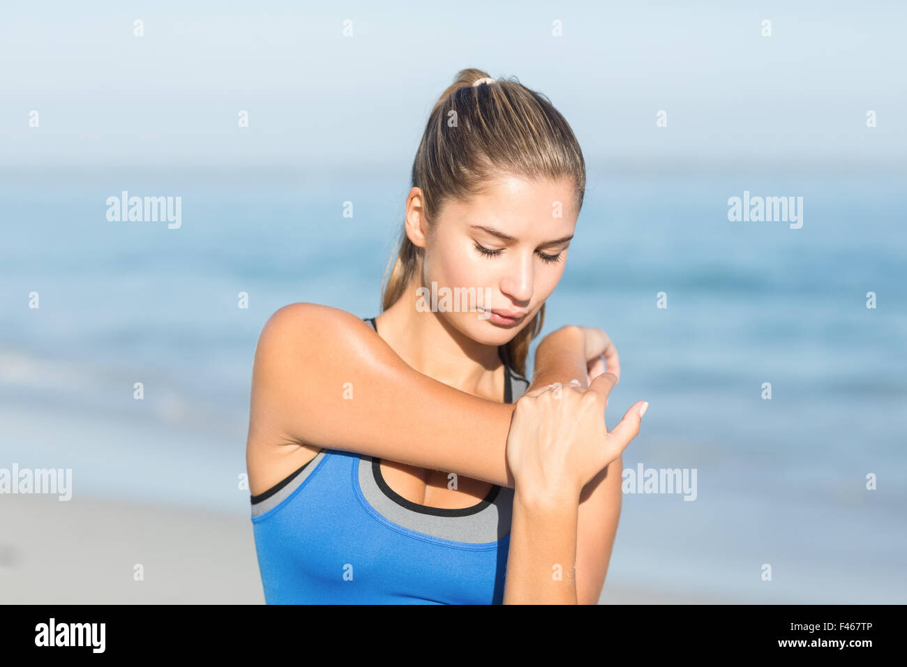 Beautiful fit woman stretching her arm Stock Photo - Alamy