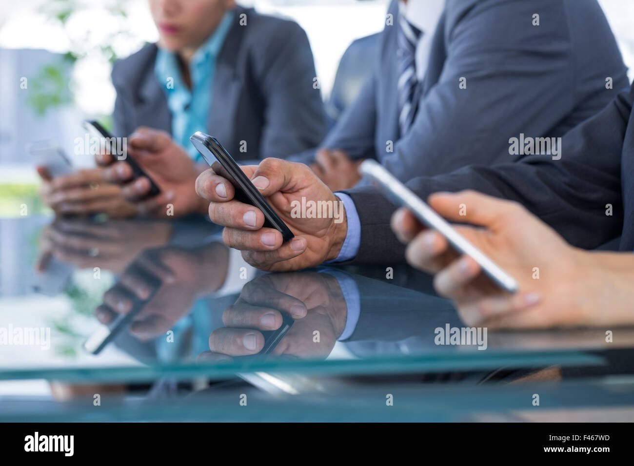 Business executives using mobile hi-res stock photography and images ...
