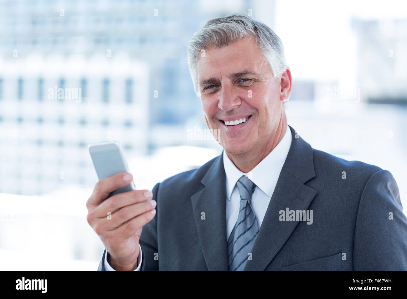 Businessman grey hair smiling using hi-res stock photography and images - Alamy