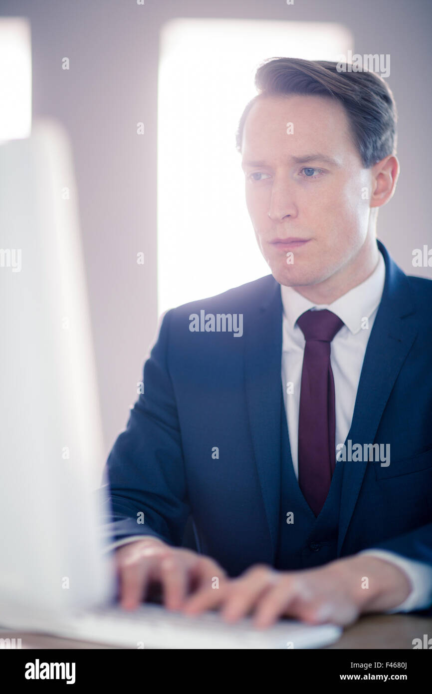 Serious businessman typing on computer Stock Photo - Alamy