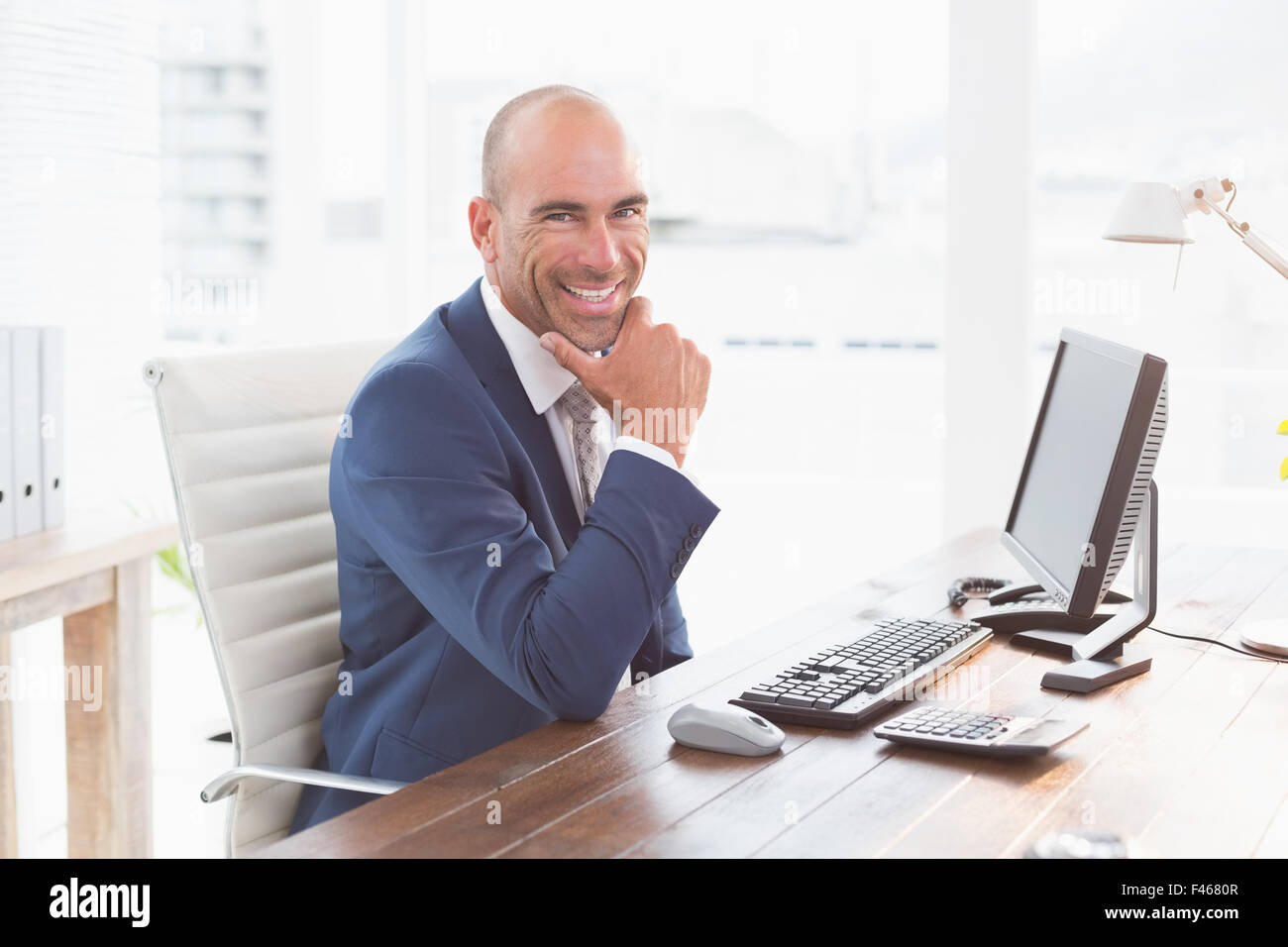 Smiling businessman looking at camera Stock Photo - Alamy